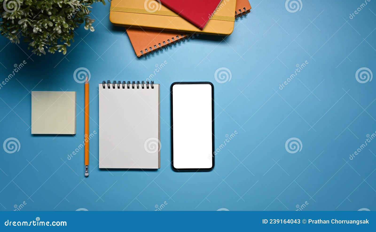 Above View Smart Phone, Notepad and Sticky Note on Blue Background ...
