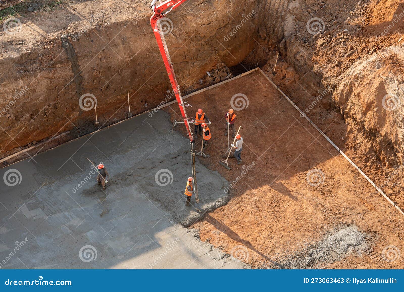 Above View of Workers Pouring Concrete at Foundation Construction Site ...