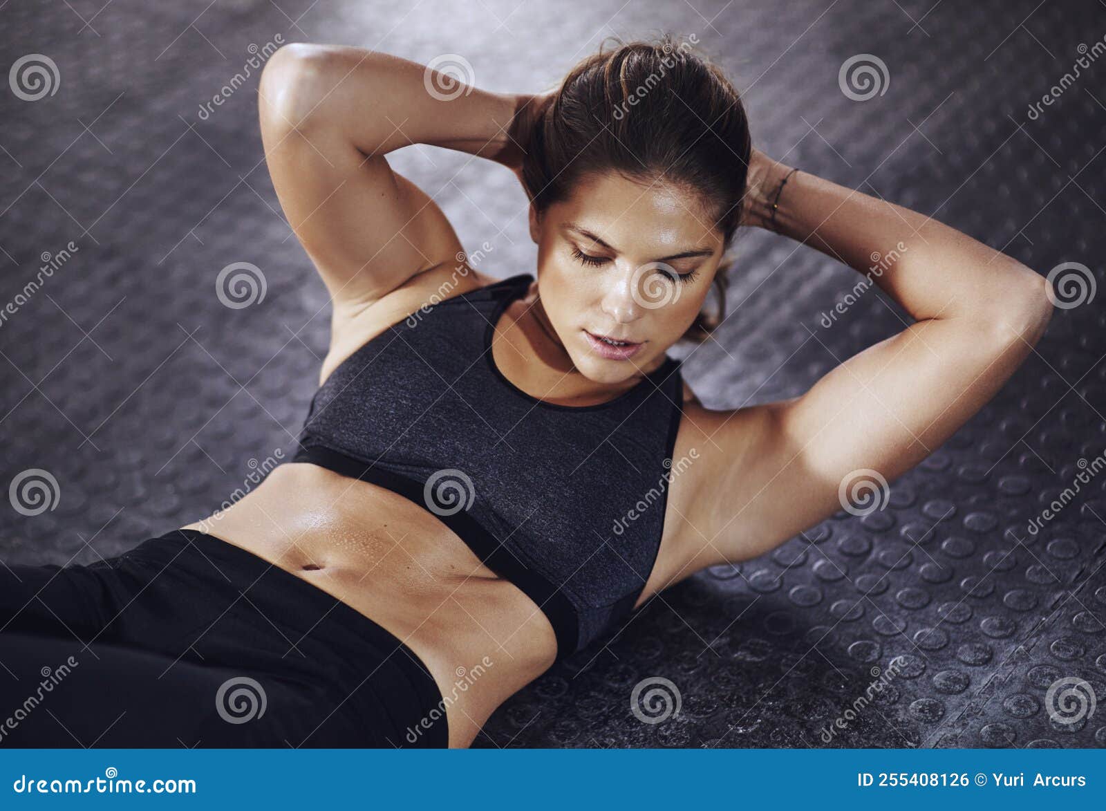 Abs-olutely Essential Exercises. a Young Woman Working Out at the Gym ...