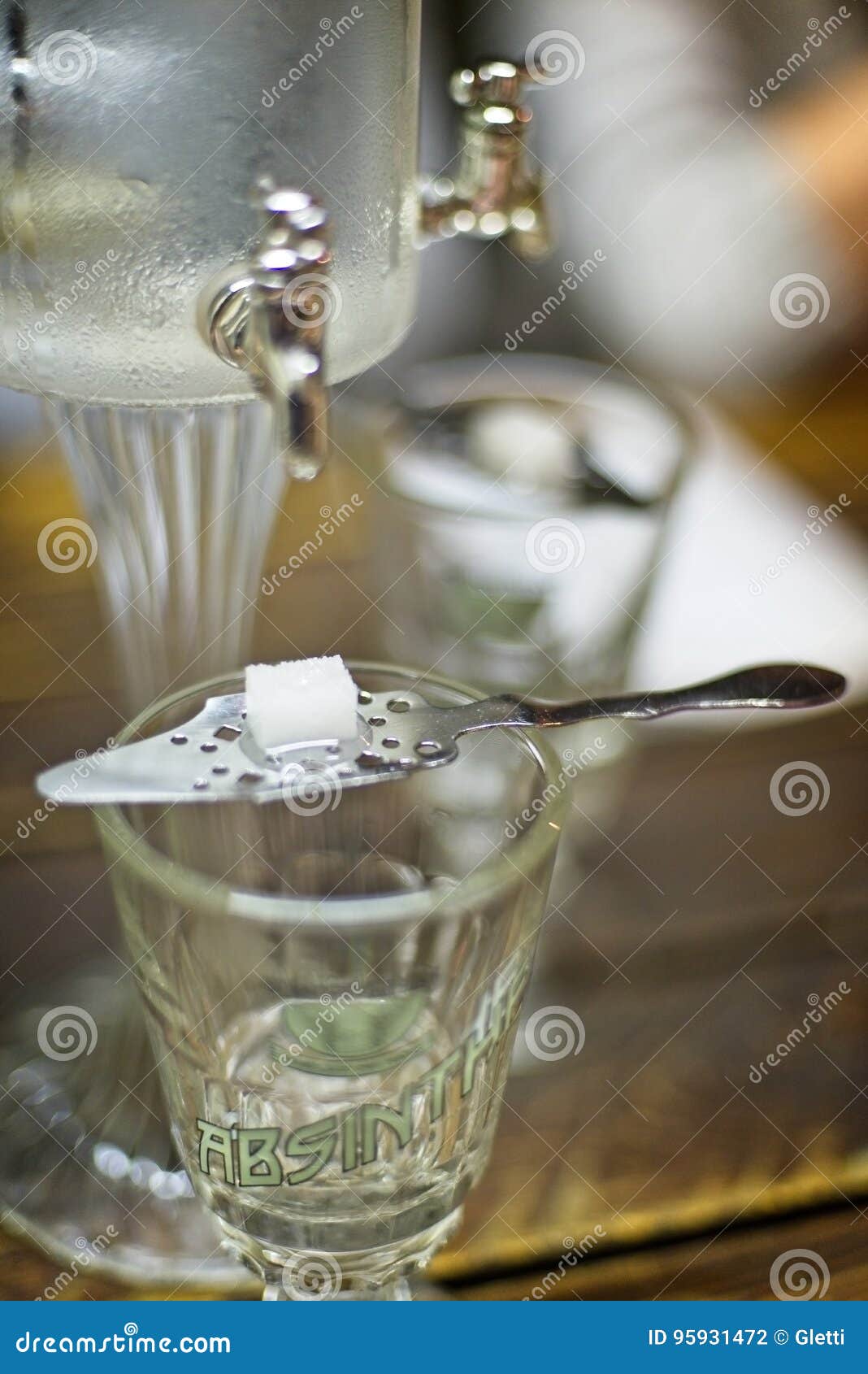 Absinth glass and fountain stock photo. Image of dripping - 95931472