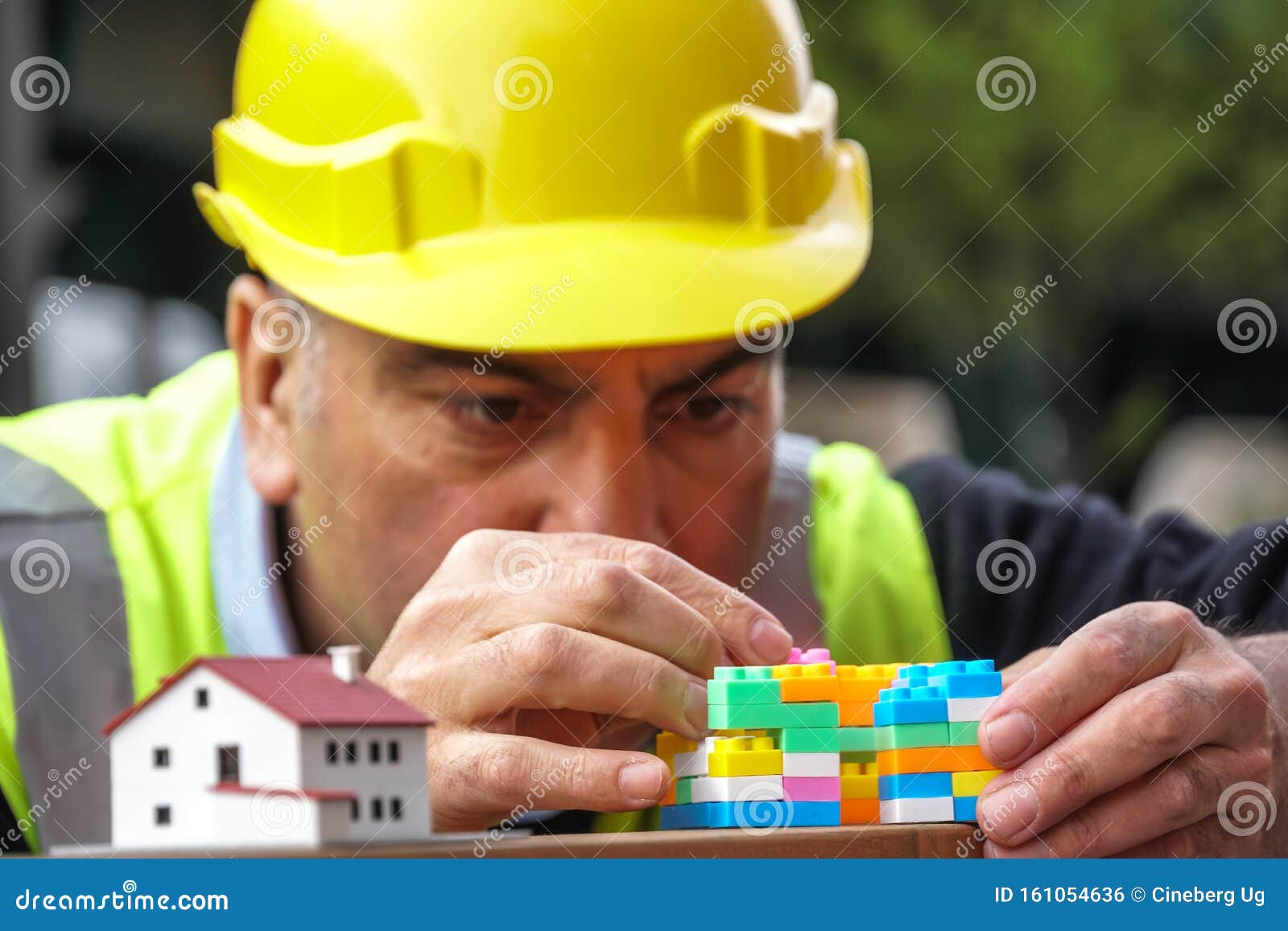 Construction Worker Using Colourful Toy Bricks Stock Photo - Image of ...