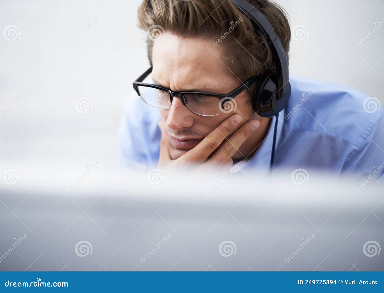 Absorbed in His Work. a Handsome Young Businessman Wearing a Headset ...