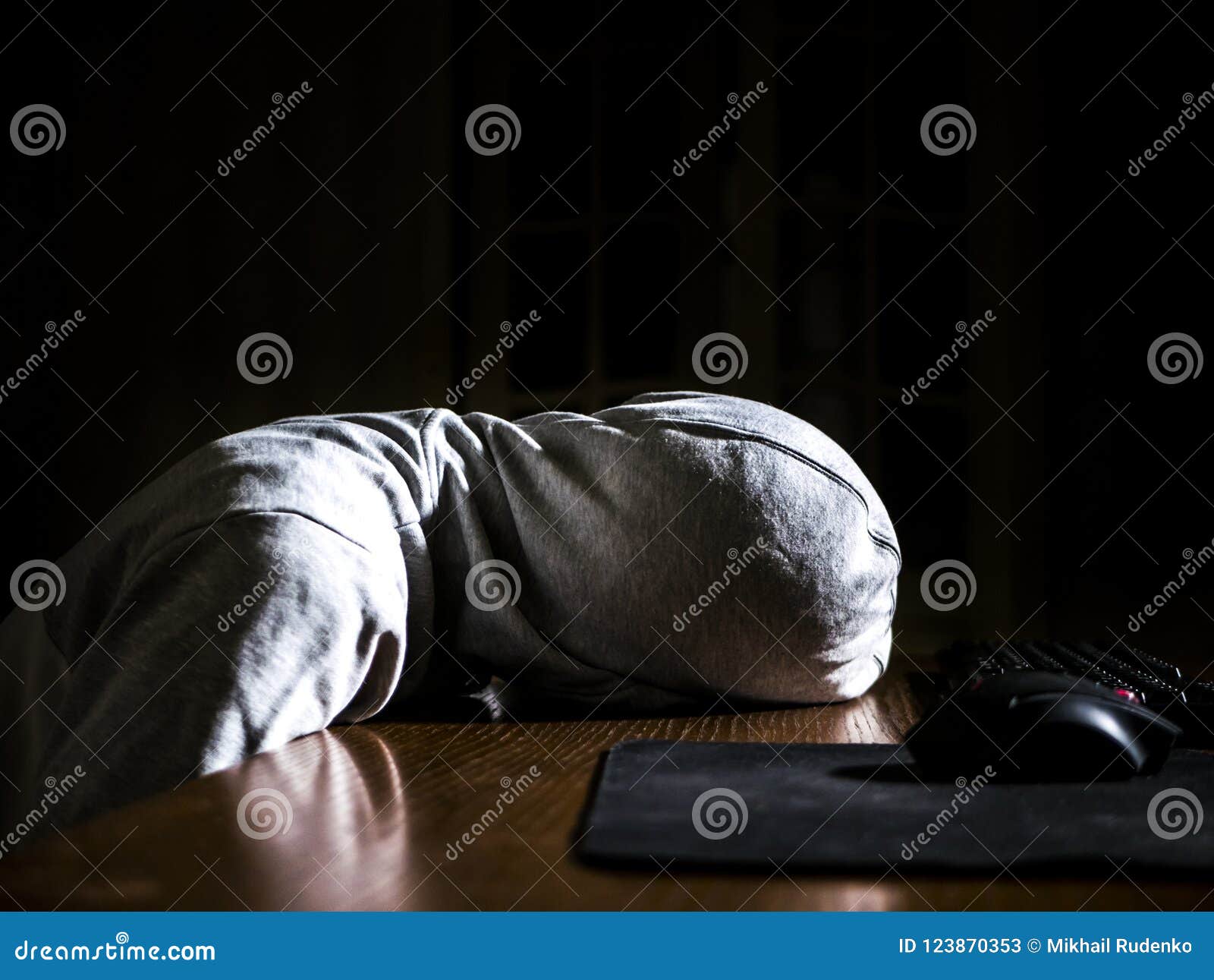 Abstract Anonymous Person in the Hood Sleeping Lying on the Table in ...