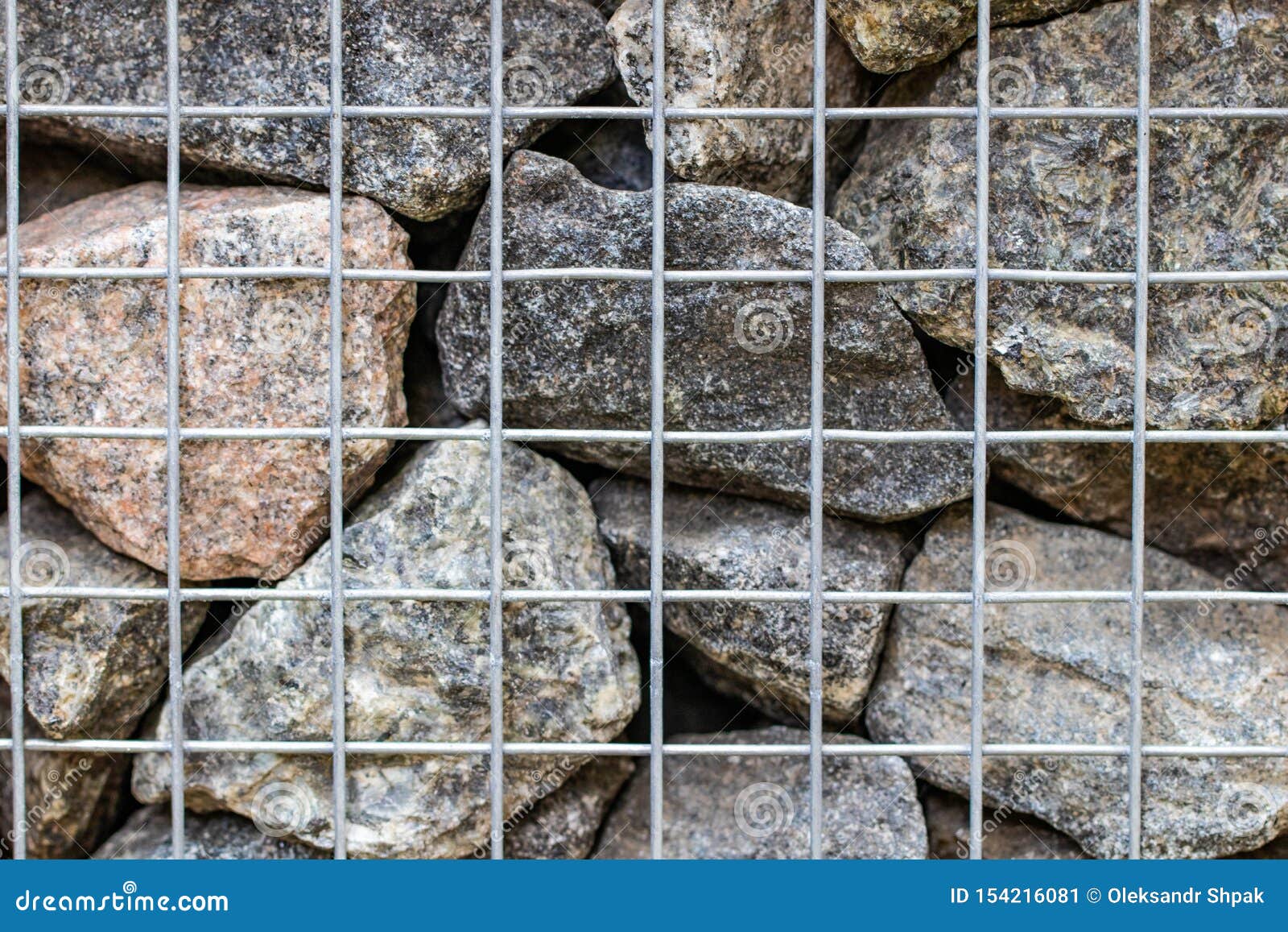 Abstract Background with Stones Behind the Net Fence Close-up Stock ...