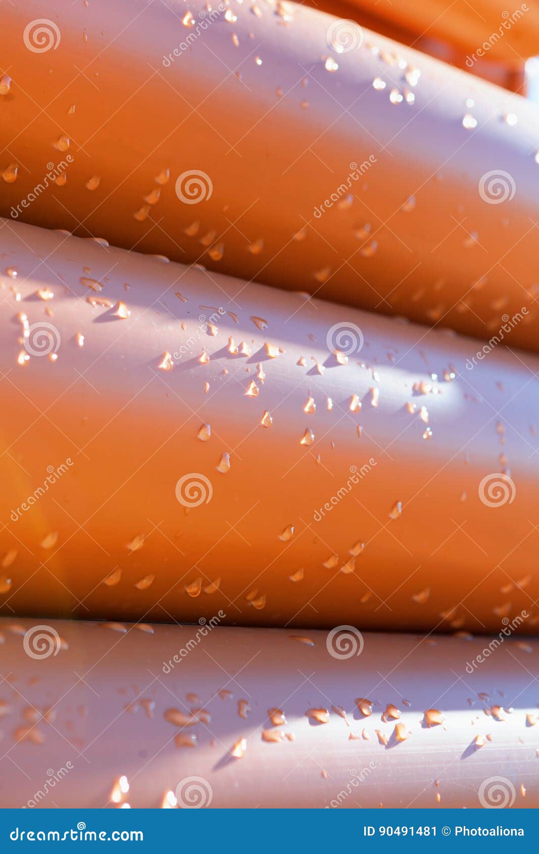 Abstract Close Up of a Stack of Orange Plastic Pipes on Construction ...