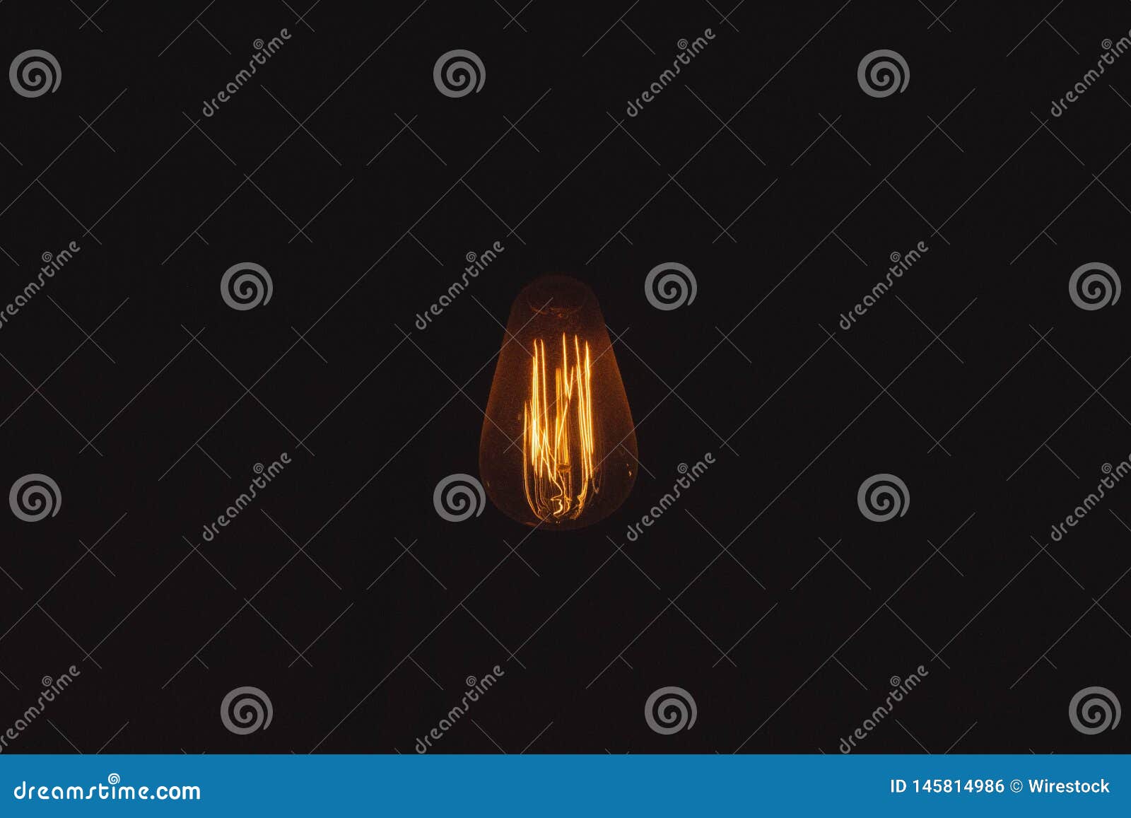 A Dim Light Bulb Lit in the Dark Stock Photo - Image of dark, abstract ...