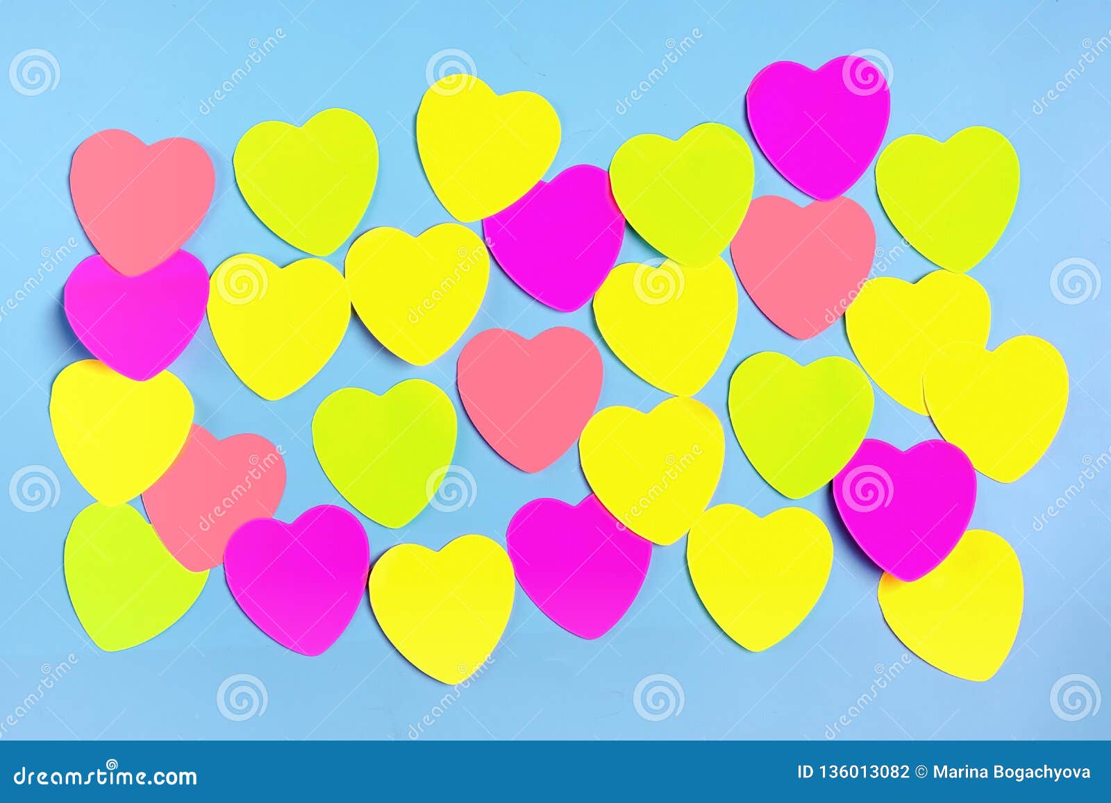 Abstract Empty Sticky Note in the Shape of a Heart Magnet on Blue Board ...