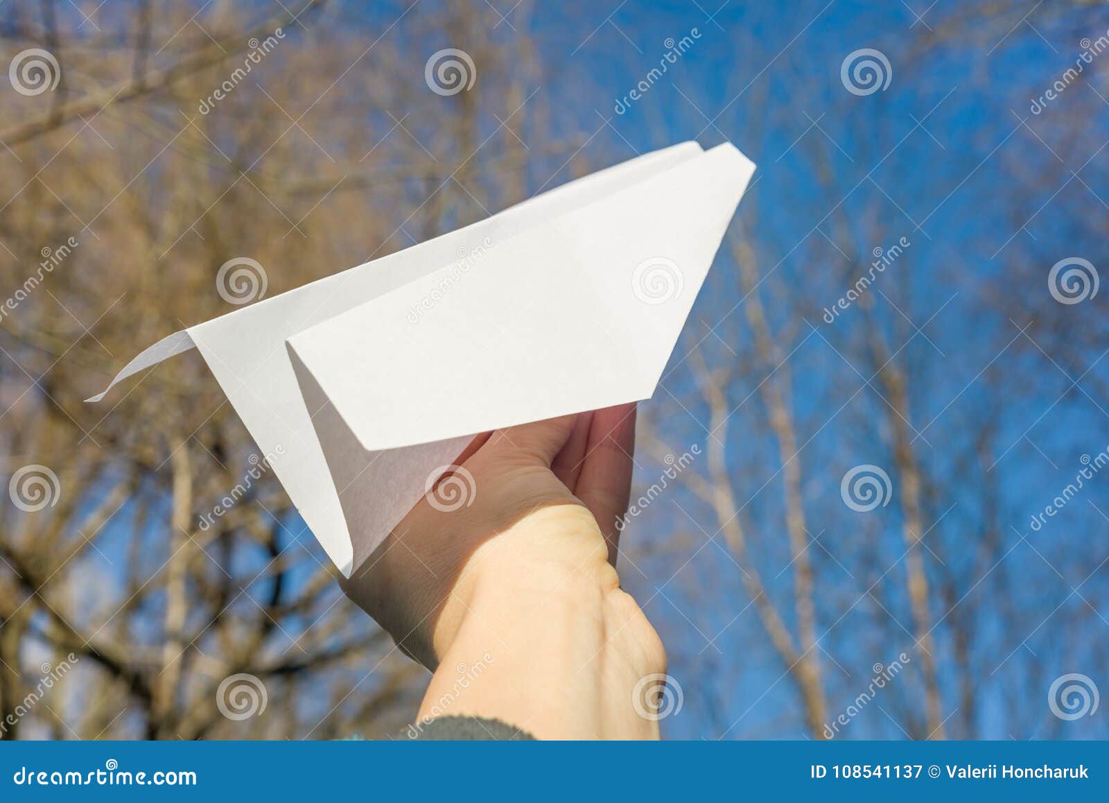 Abstract Paper Plane in Hand, Blue Sky, Spring Trees Sun Background ...