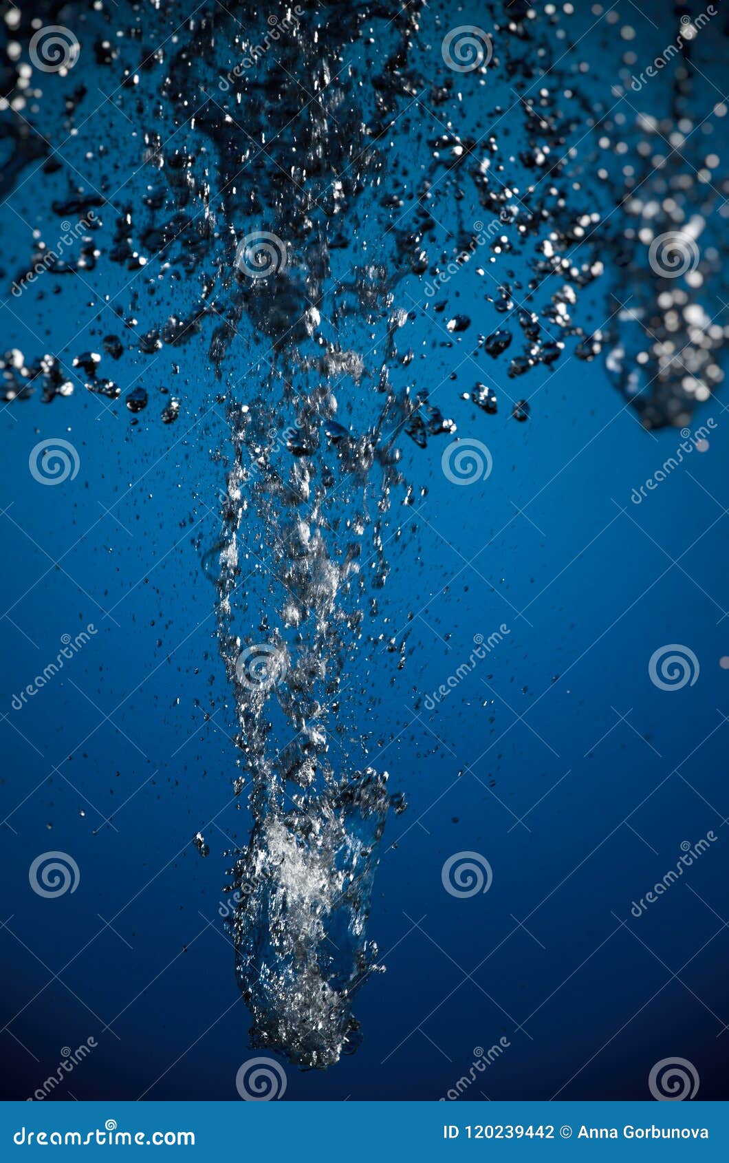 Abstract Splash of Silver Colored Liquid on Blue Background Stock Photo ...