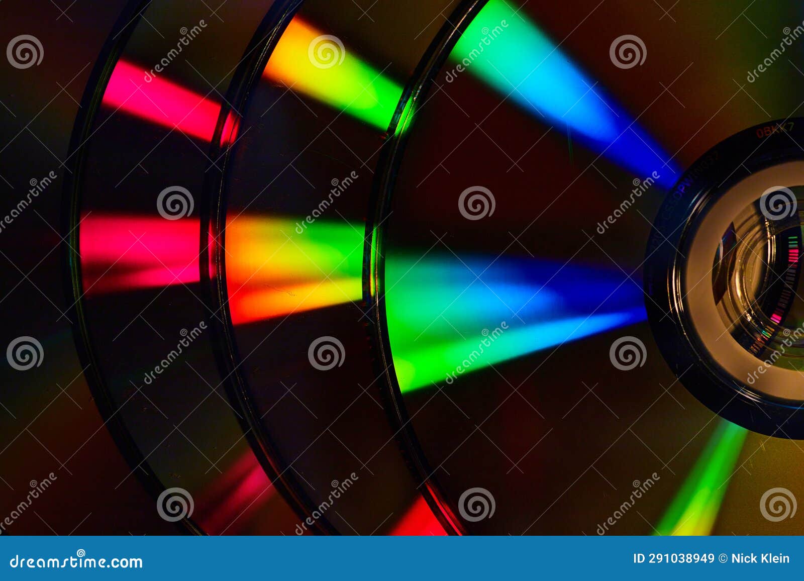 Abstract Stack of Four Dark Silvery CDs with Reflective Rainbow Colored ...