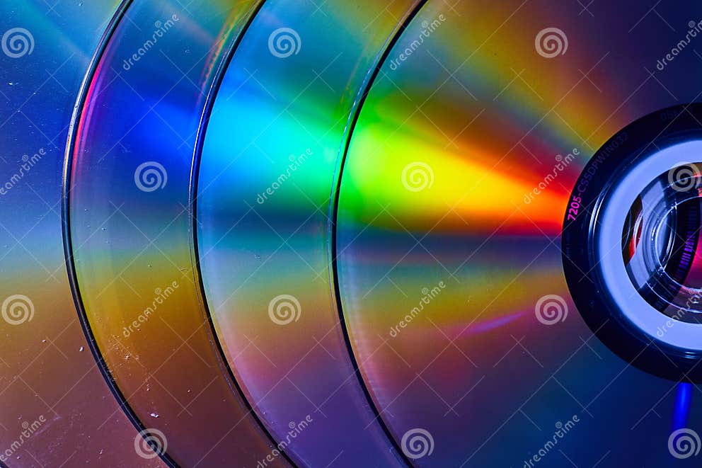 Abstract Stack of Four Silvery CDs with Reflective Rainbow Bursts of ...