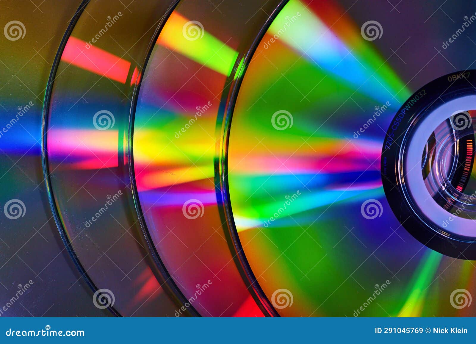 Abstract Stack of Four Silvery CDs with Reflective Rainbow Colored ...
