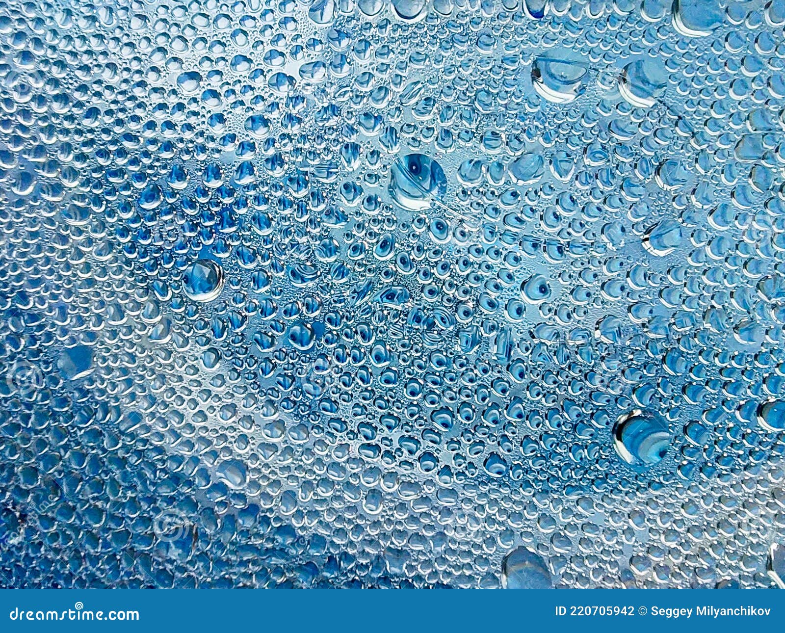 An Abstraction. Drops of Water, Dew, on the Blue Glass Stock Photo ...