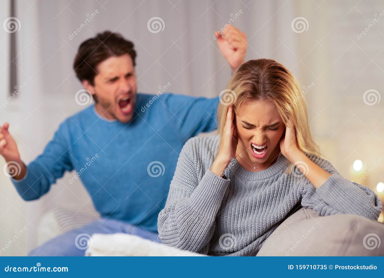 Aggressive Man Yelling at Girlfriend Sitting on Sofa at Home Stock ...
