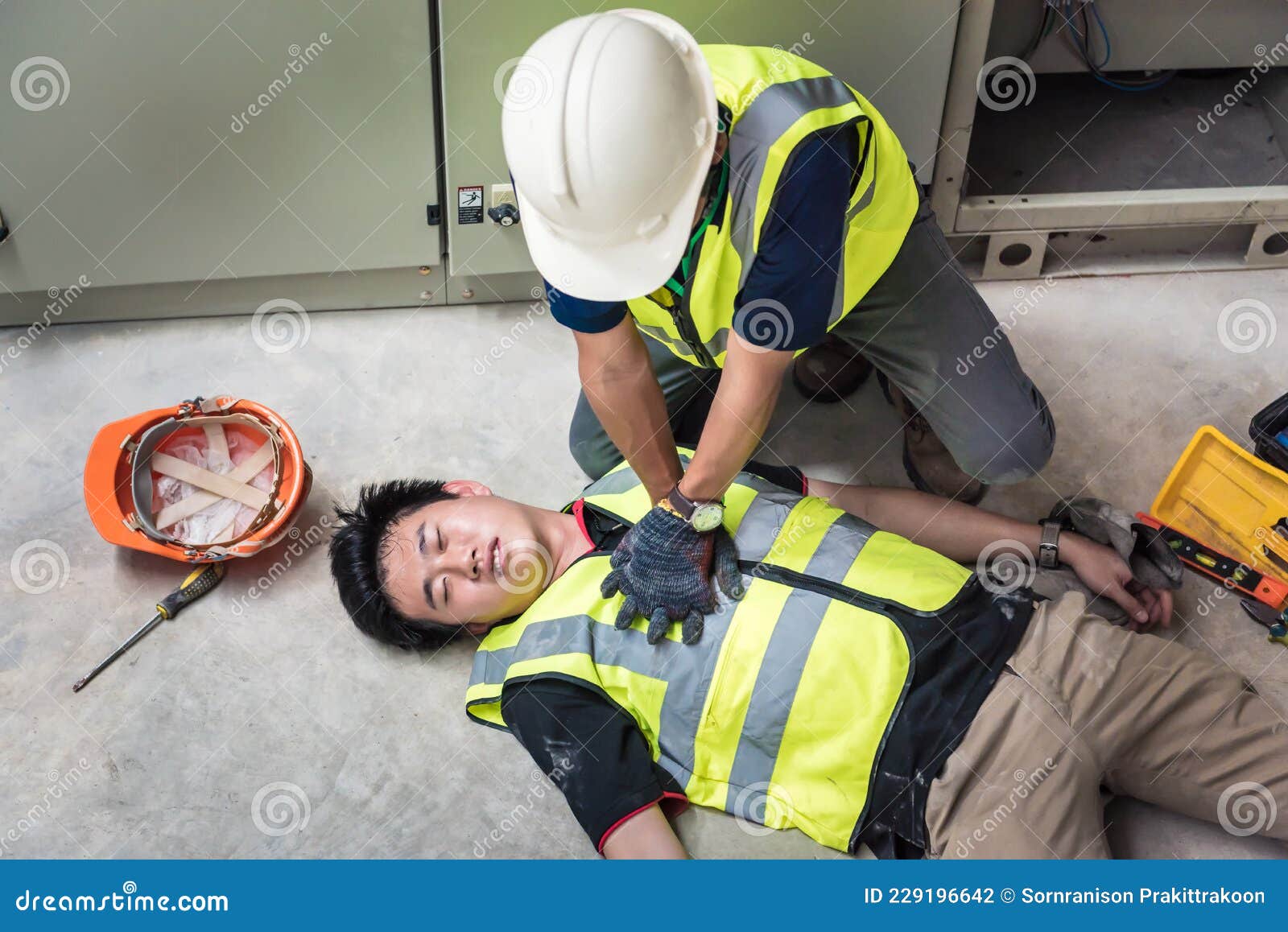 Accident in Industrial Work with First Aid Stock Photo - Image of help ...