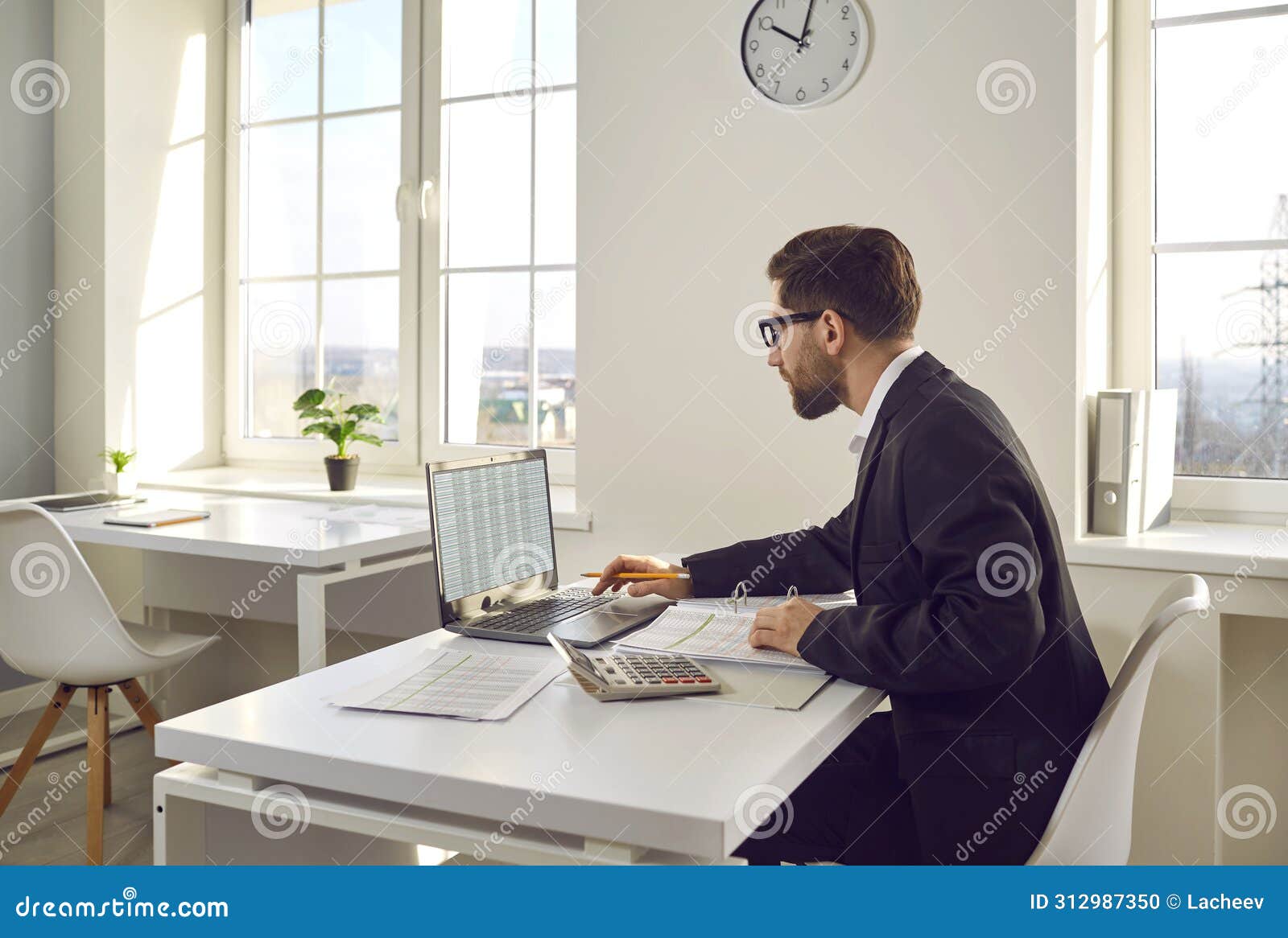Accountant Sitting at His Office Desk and Working with Data Sheets on a ...