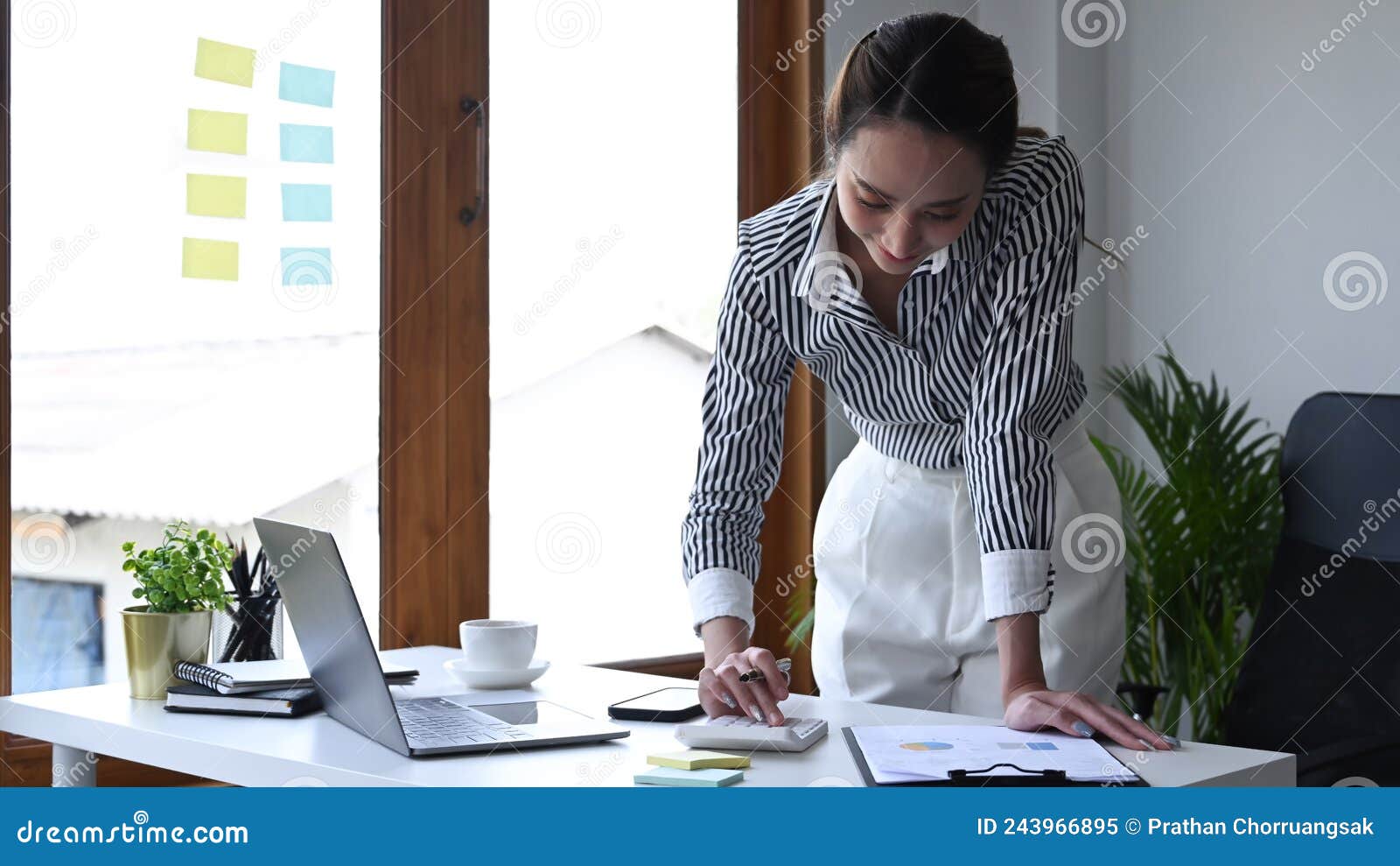 Accountant Standing and Using Calculator at Office Desk. Stock Image ...