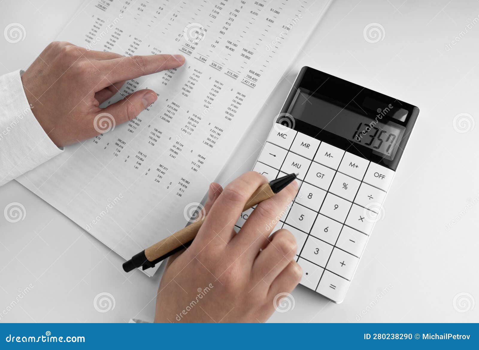 Accountant Using a Calculator and Points Her Finger at the Numbers in ...