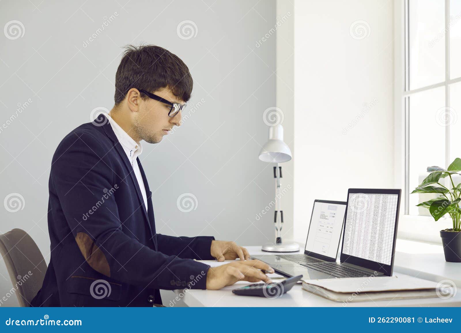 Accountant Using Calculator and Working with Digital Business Documents ...