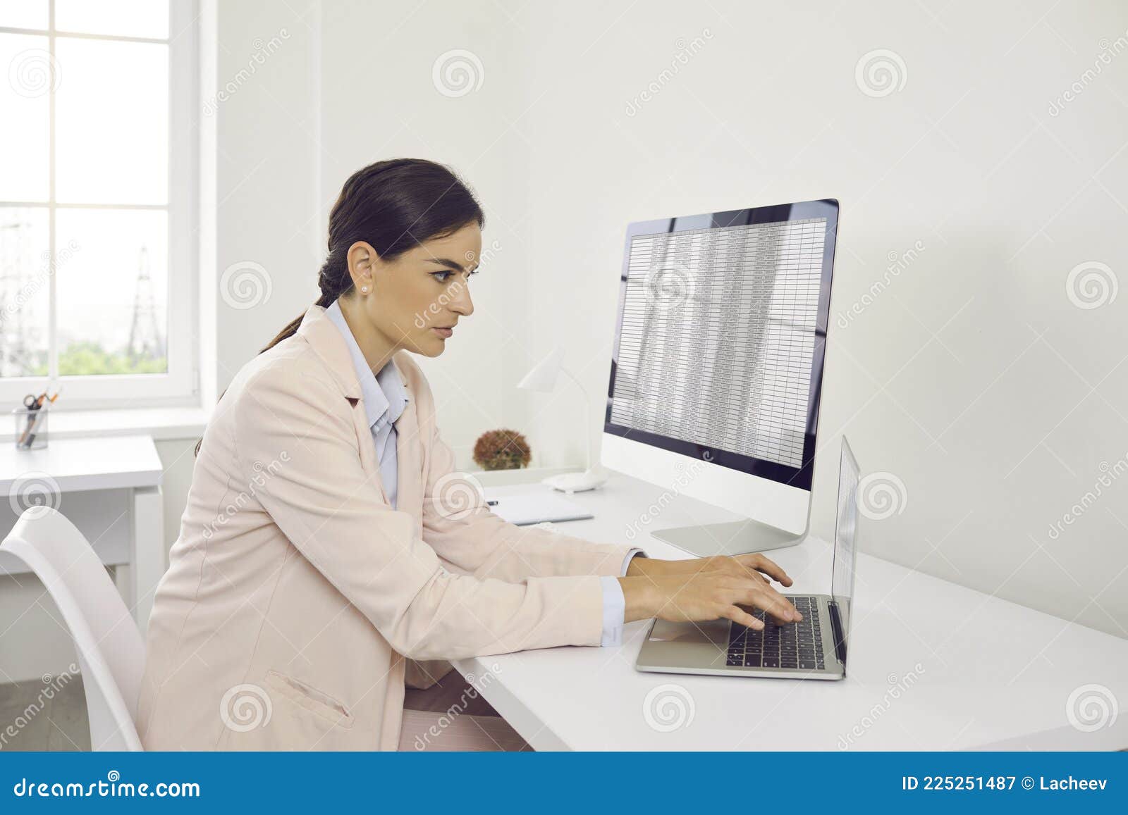 Accountant Working on Laptop while Sitting at Her Office Desk with ...