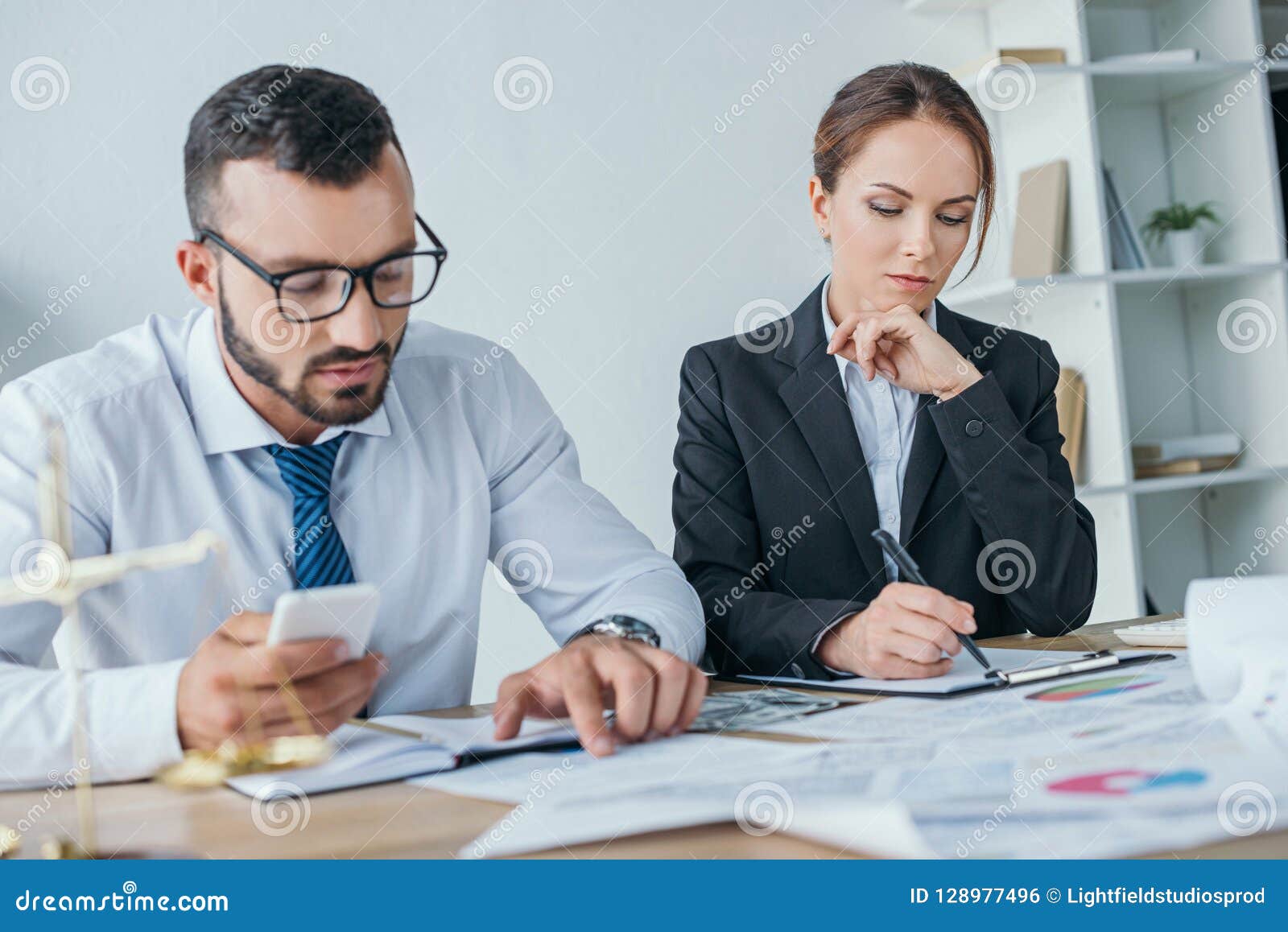 Accountants Working with Documents and Using Smartphone Stock Photo ...