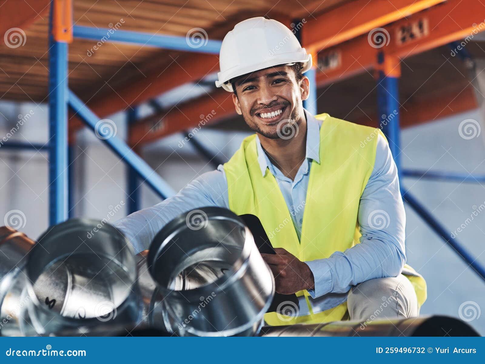 Accounting for Everything. a Handsome Young Contractor Crouching Down ...