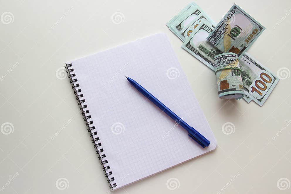 Accounting for Expenses. on the White Surface of the Table is a Notepad ...