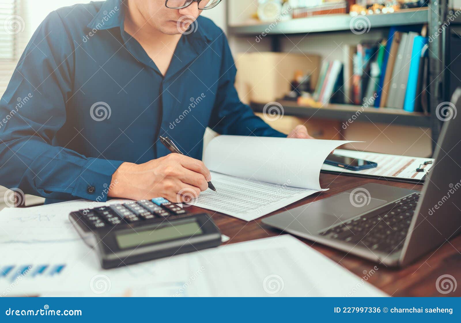 Accounting Woking with Data Sheet on the Office Desk. Calculator with ...