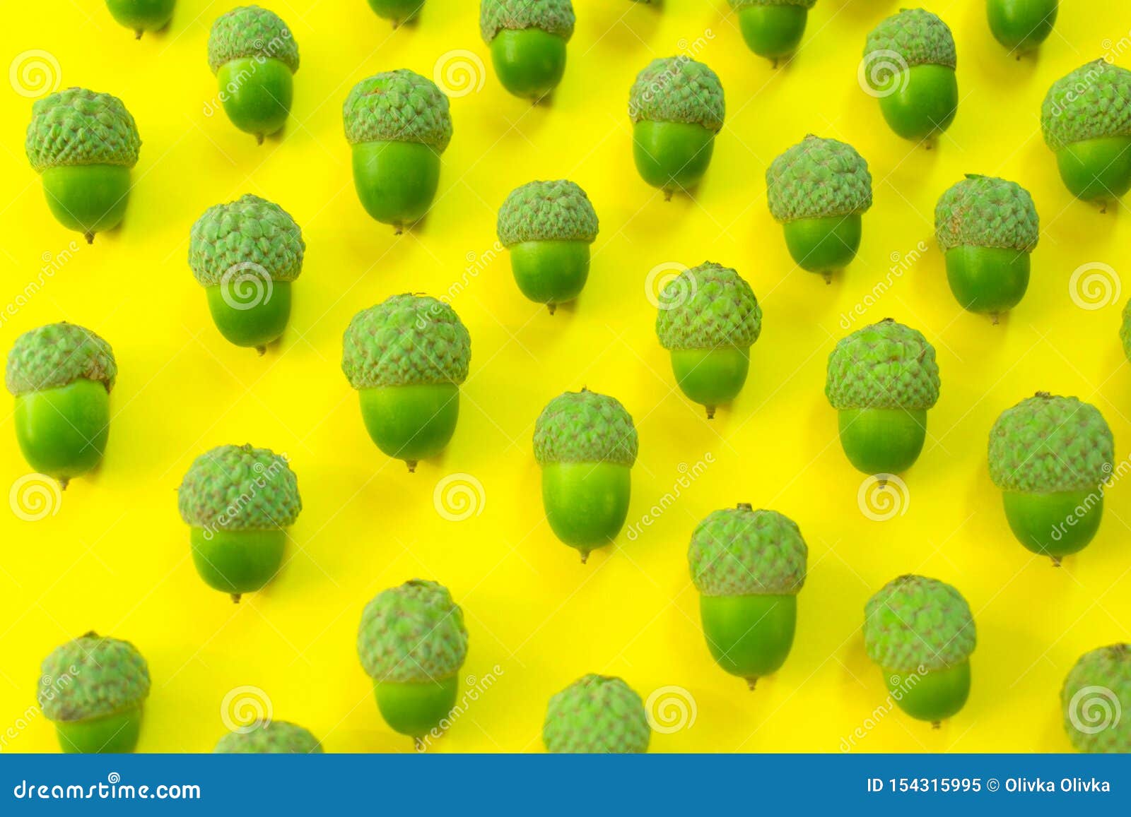 Acorns Pattern Lined Up on a Yellow Background. Top View, Flat Lay ...
