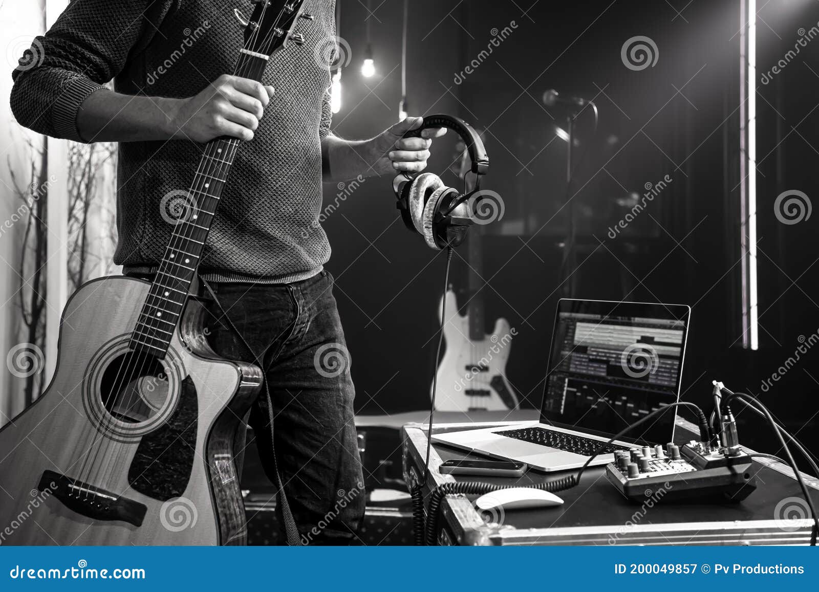 An Acoustic Guitar in the Hands of a Man in a Recording Studio in the ...