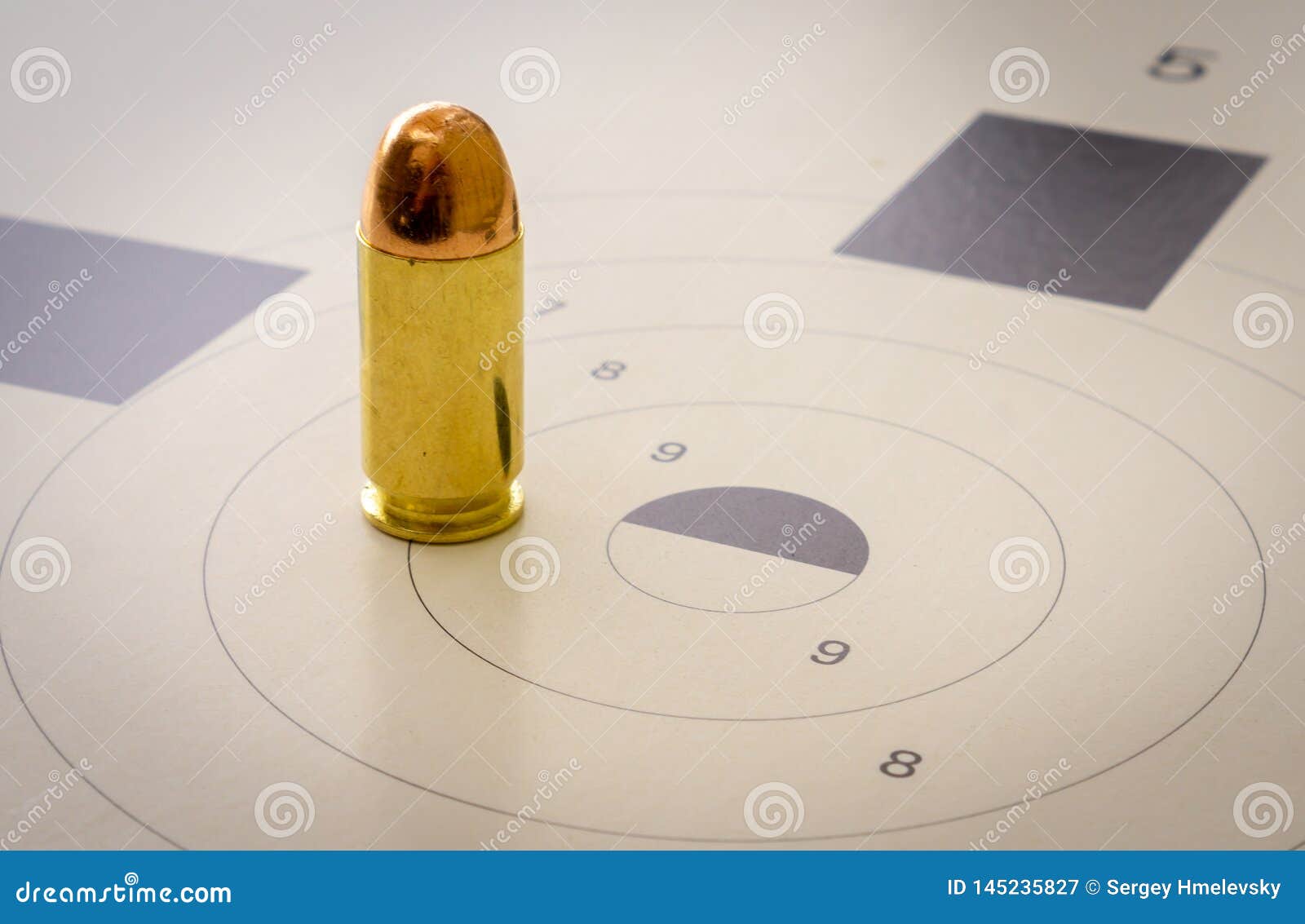 A 45 Acp Bullet with a Paper Target in the Background Stock Image ...