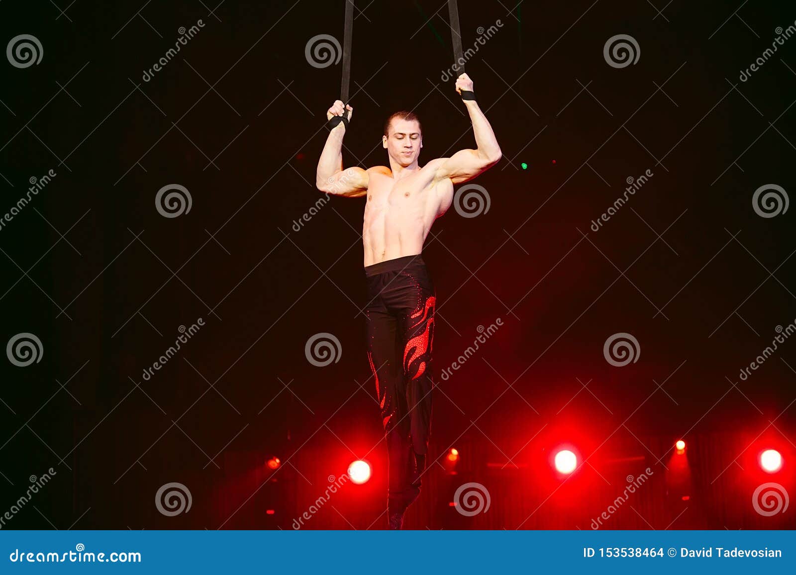 Acrobat Performs a Difficult Trick in the Circus. Stock Photo - Image ...