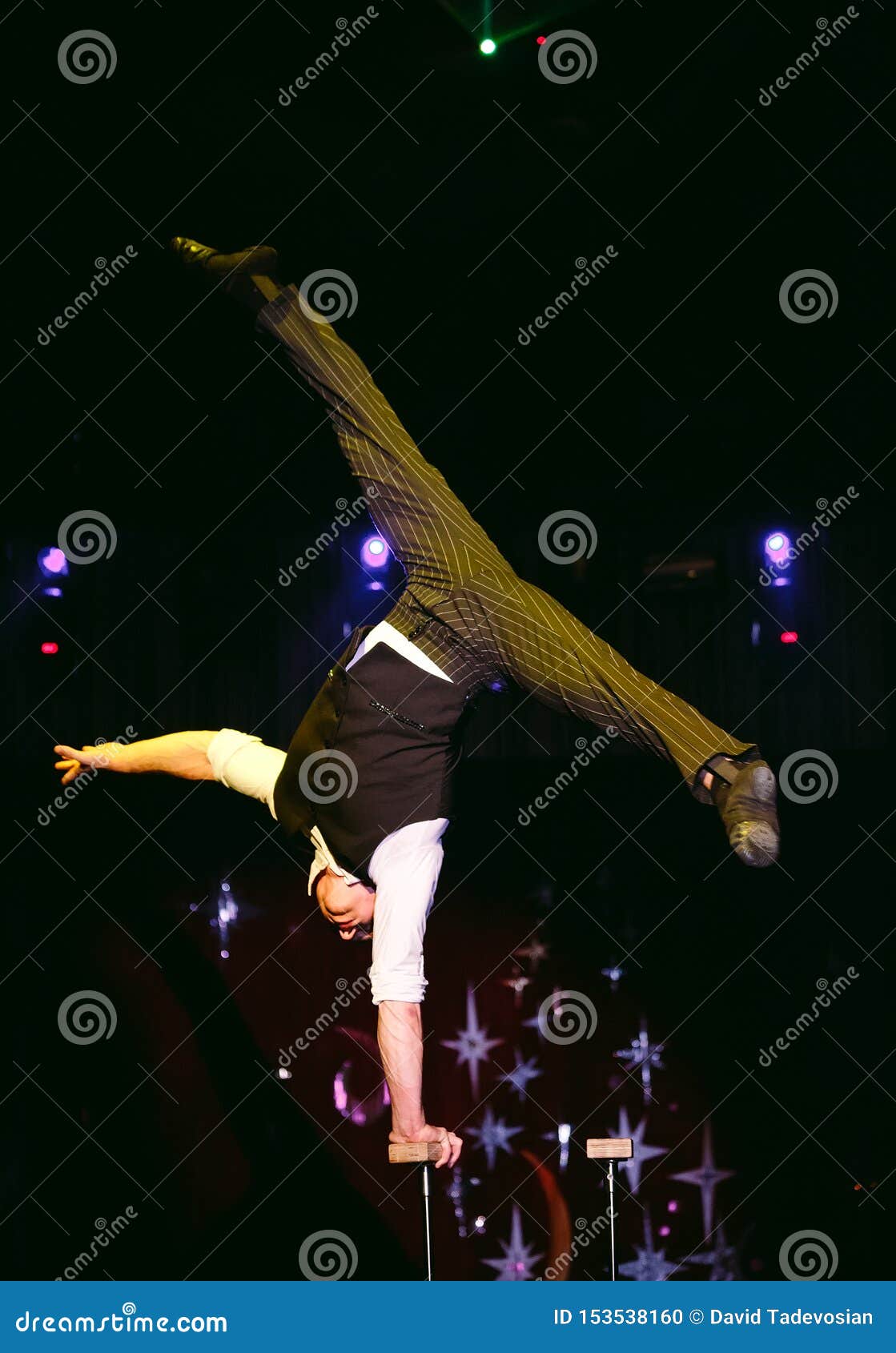 Acrobat Performs a Difficult Trick in the Circus. Stock Photo - Image ...