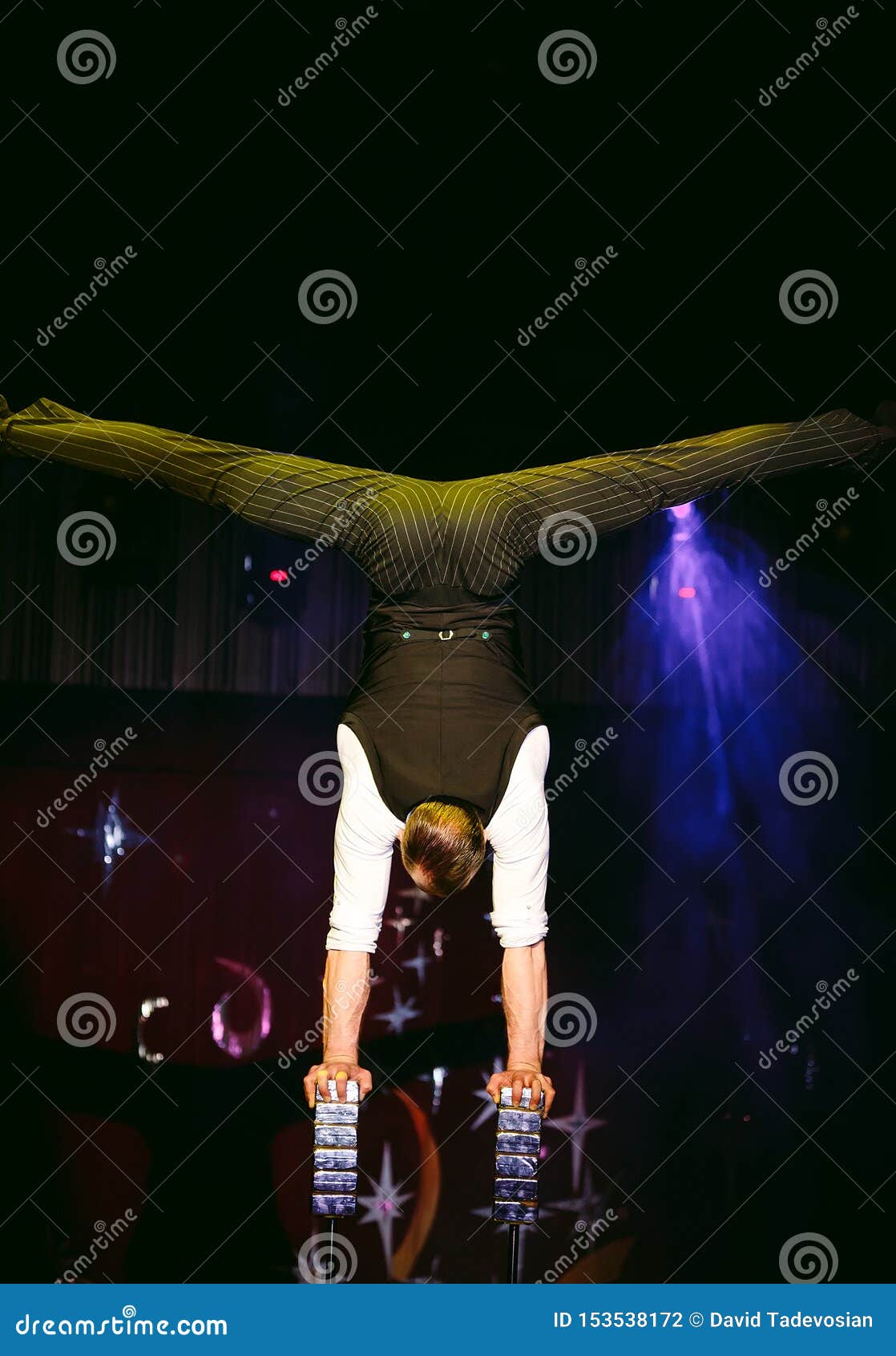 Acrobat Performs a Difficult Trick in the Circus. Stock Photo - Image ...