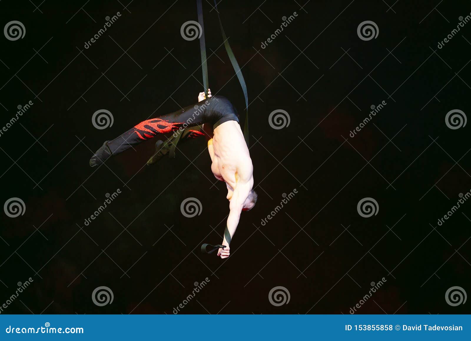 Acrobat Performs a Difficult Trick in the Circus. Stock Photo - Image ...