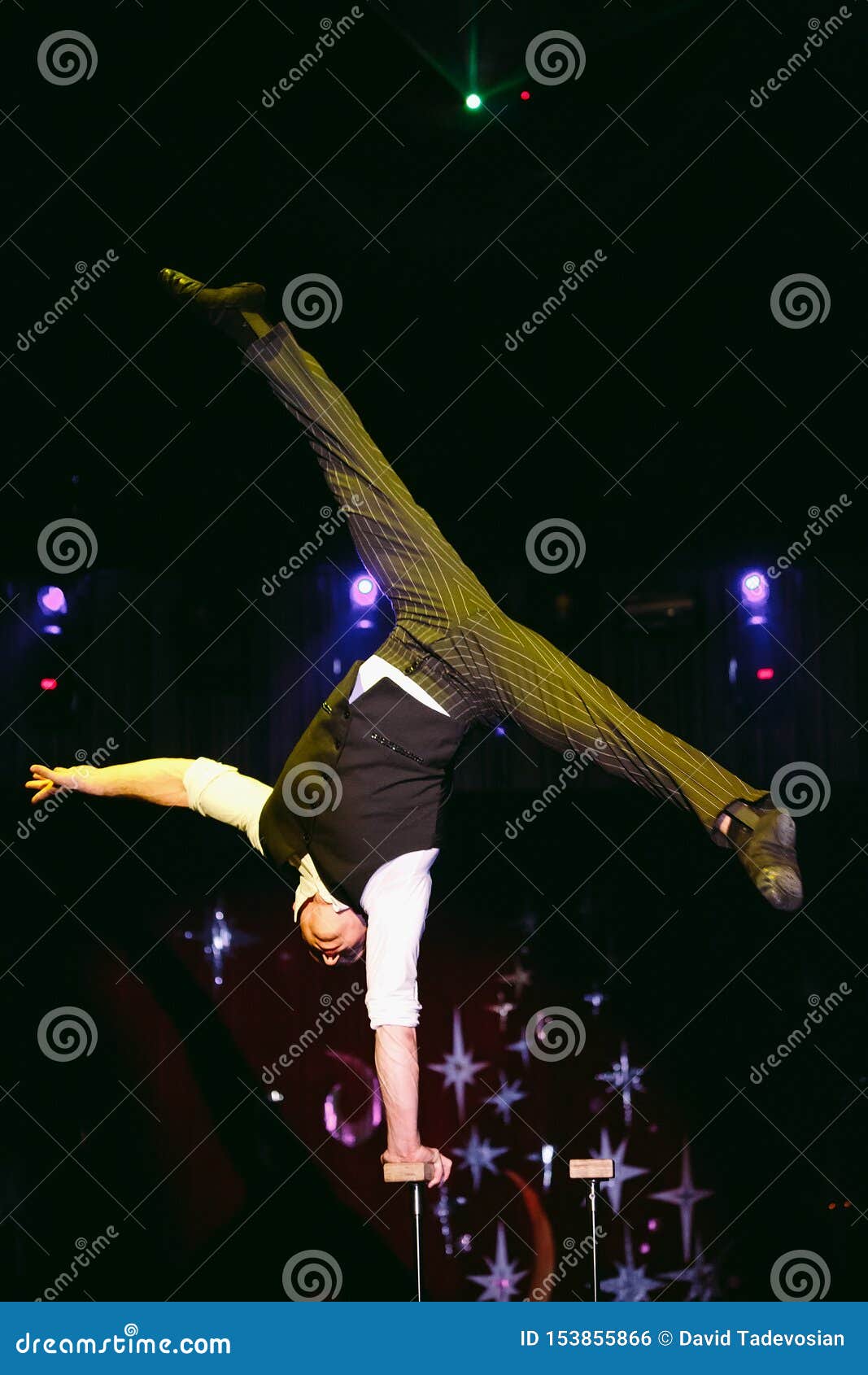Acrobat Performs a Difficult Trick in the Circus. Stock Photo - Image ...