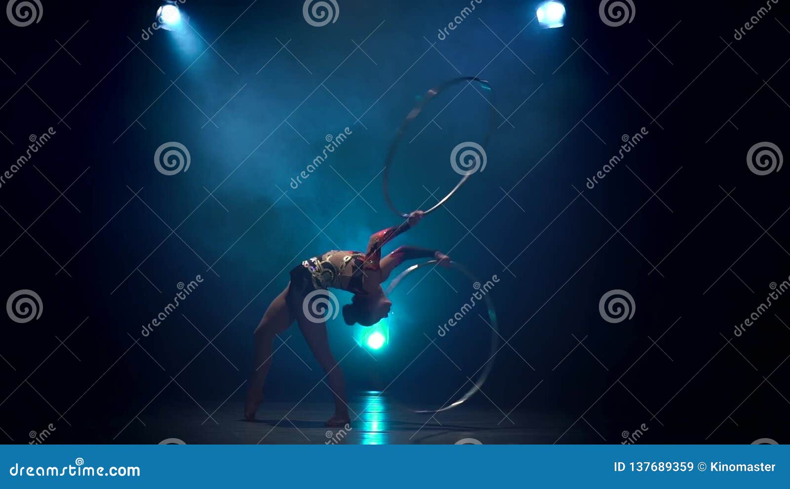Acrobat Performs with Hoops. Blue Smoke Background. Slow Motion Stock ...