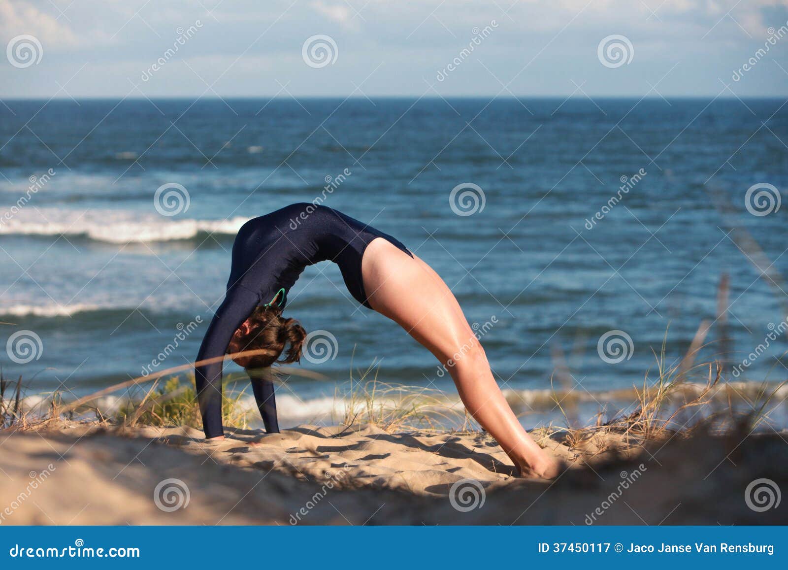 Acrobatic Gymnast Is Arching Her Back On The Beach Stock Image ...