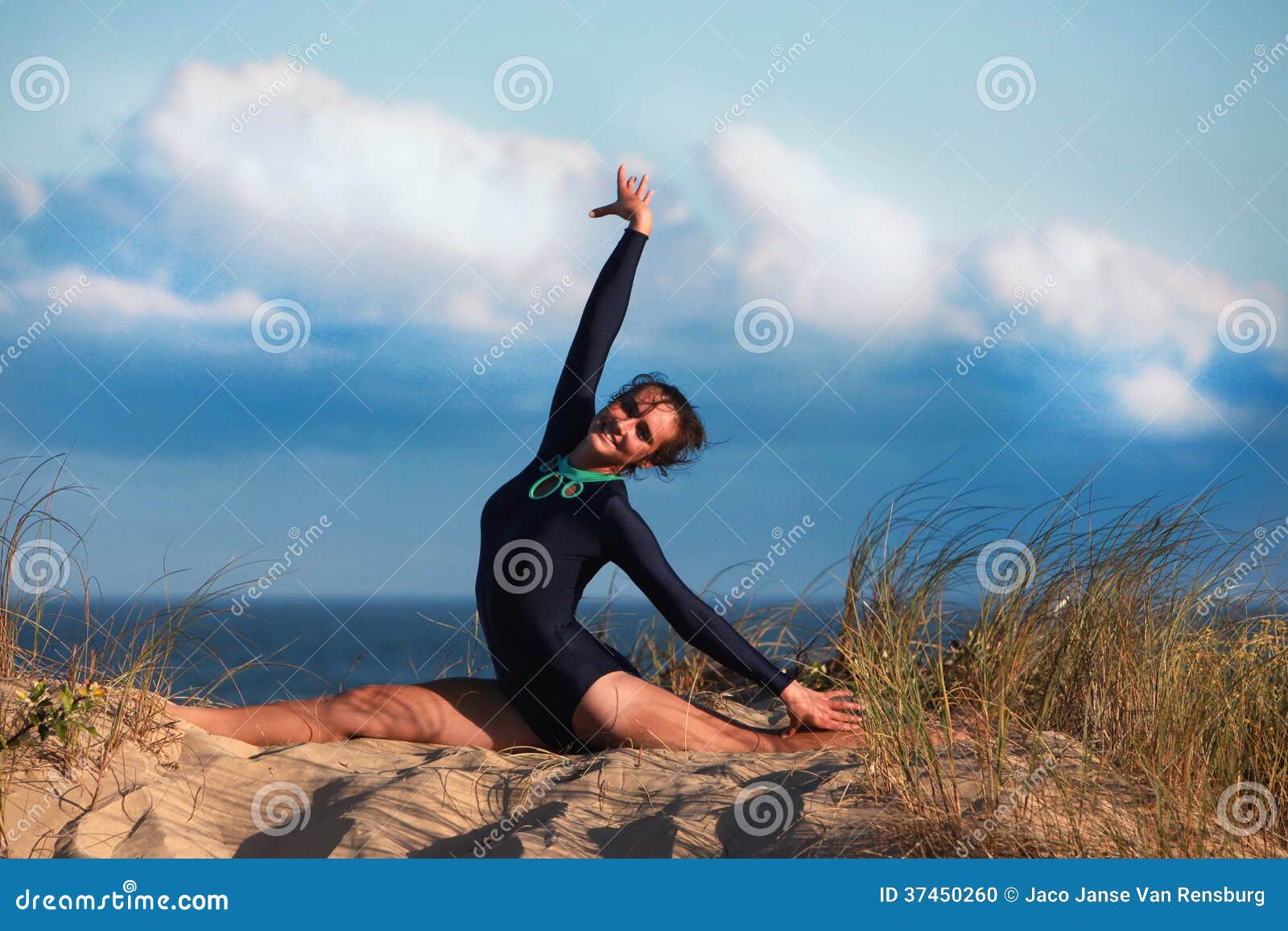 Acrobatic Gymnast is Doing the Split on the Beach Stock Photo - Image ...