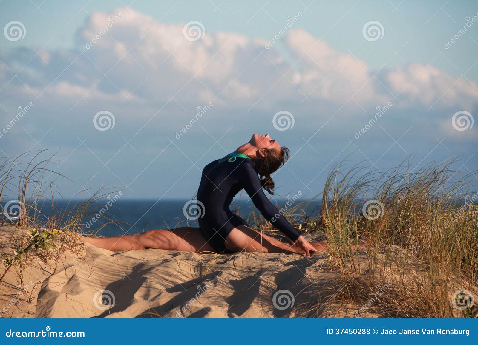 Acrobatic Gymnast is Doing the Split on the Beach Stock Photo - Image ...
