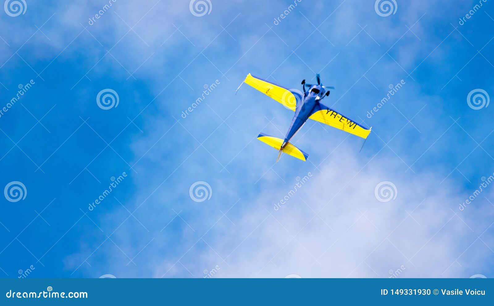 An Acrobatic Plane, Flying in the Blue Sky with White Clouds, Doing ...