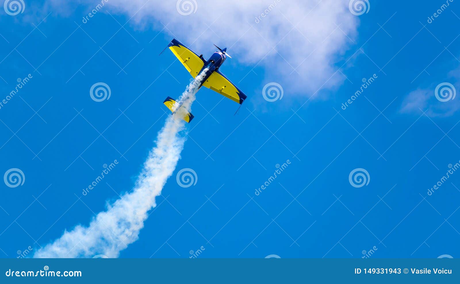 An Acrobatic Plane, Flying in the Blue Sky with White Clouds, Doing ...