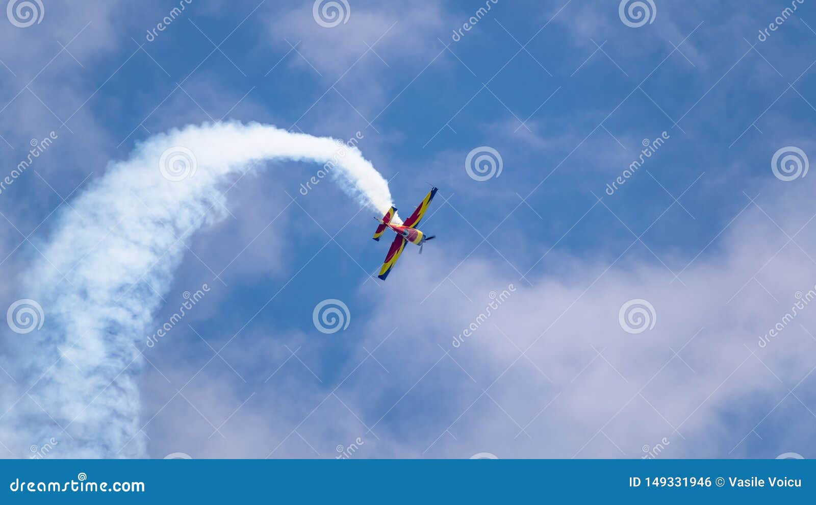 An Acrobatic Plane, Flying in the Blue Sky with White Clouds, Doing ...