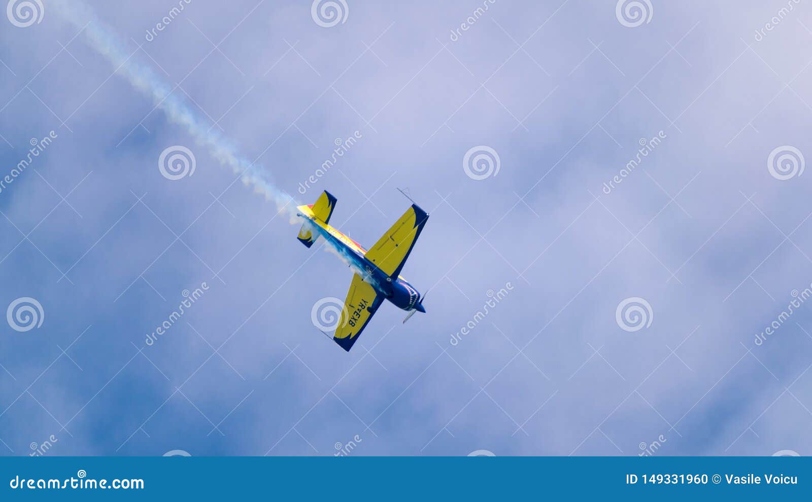 An Acrobatic Plane, Flying in the Blue Sky with White Clouds, Doing ...
