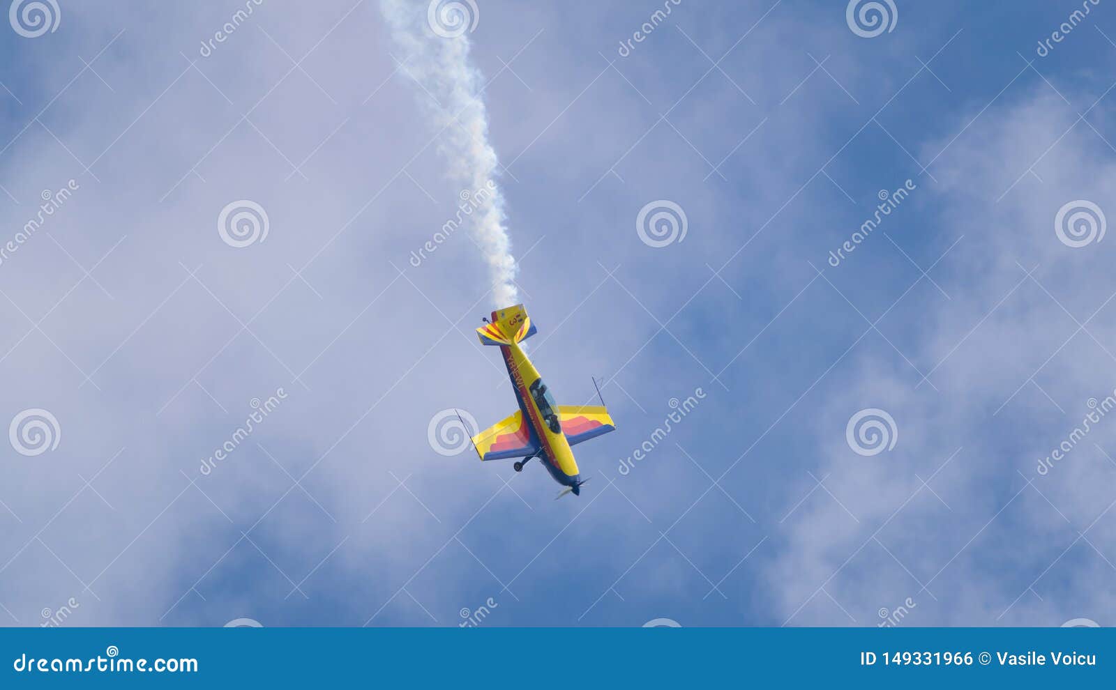 An Acrobatic Plane, Flying in the Blue Sky with White Clouds, Doing ...