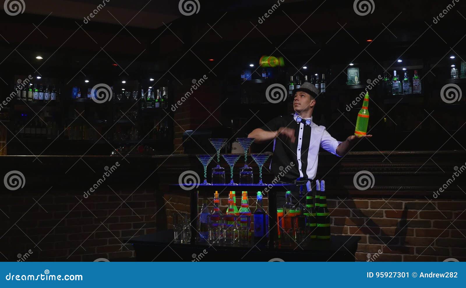 Acrobatic Show Performed by Barman Juggling Bottle. Bar Background ...