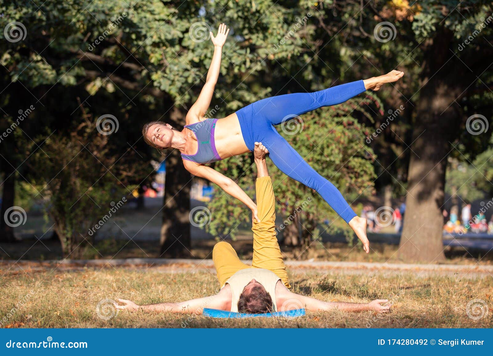 Acroyoga Couple Doing Side Star Pose in the Park Stock Photo - Image of ...