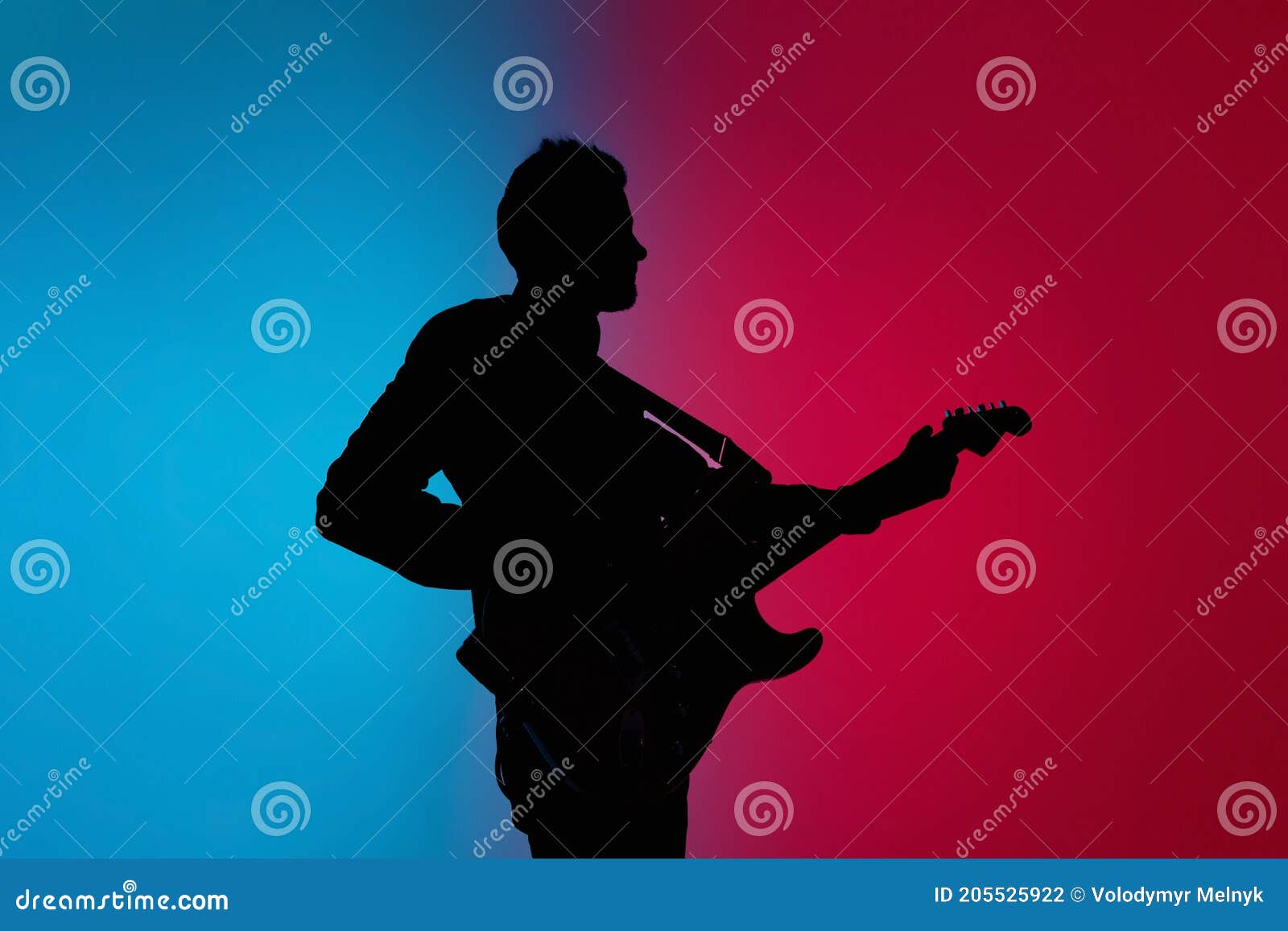 Silhouette Of Young Caucasian Male Guitarist Isolated On Blue Pink