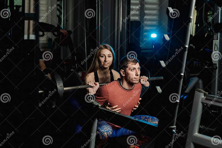 Active Beautiful Fitness Model Girl Insists On Squatting An Athletic