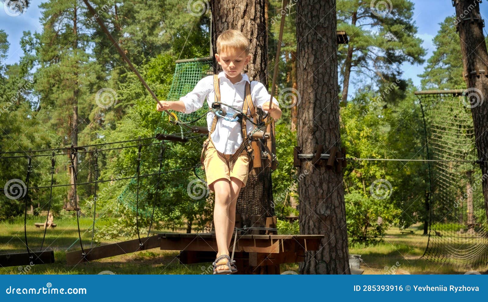 Active Boy Climbing and Walking Over Rope Bridge in Park Stock Photo ...